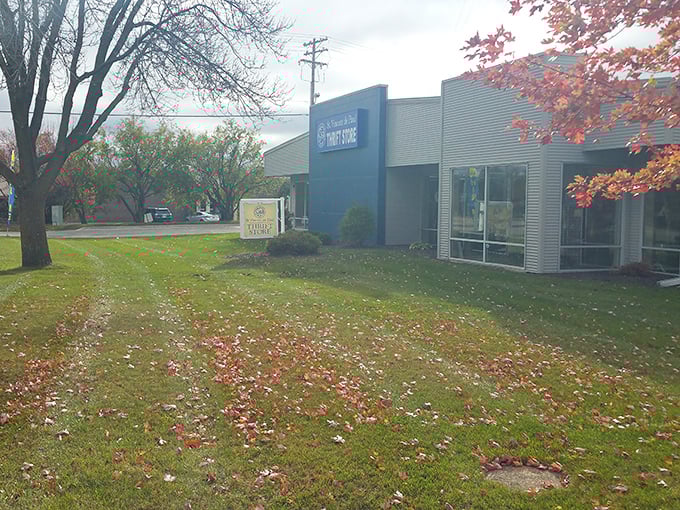 Even in autumn's embrace, the distinctive blue fa&ccedil;ade stands out like a sapphire among fallen leaves, quietly promising treasures inside.