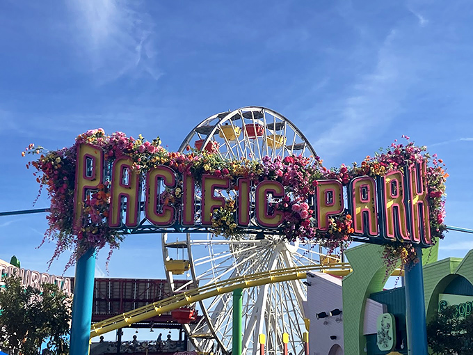 Flower-draped letters spell out childhood wonder at Pacific Park's entrance, beckoning visitors with a technicolor invitation to play.