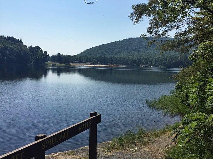 The Spillway Trail sign stands guard over tranquil waters. This is what your blood pressure looks like after an hour at Cowans Gap&mdash;perfectly still.