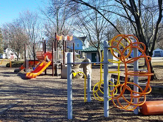 Colorful playground equipment stands ready for childhood adventures, no smartphone app required for this kind of entertainment.