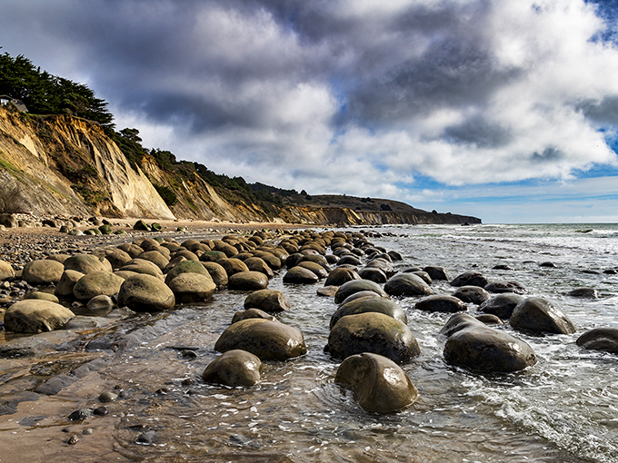 Perfectly rounded sentinels stand guard against the tide. These aren't just rocks&mdash;they're time capsules from Earth's prehistoric scrapbook.