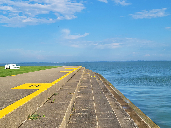 This yellow-lined seawall isn't just infrastructure; it's front-row seating to Lake Erie's daily performance of waves, wind, and the occasional dramatic seagull dispute. 