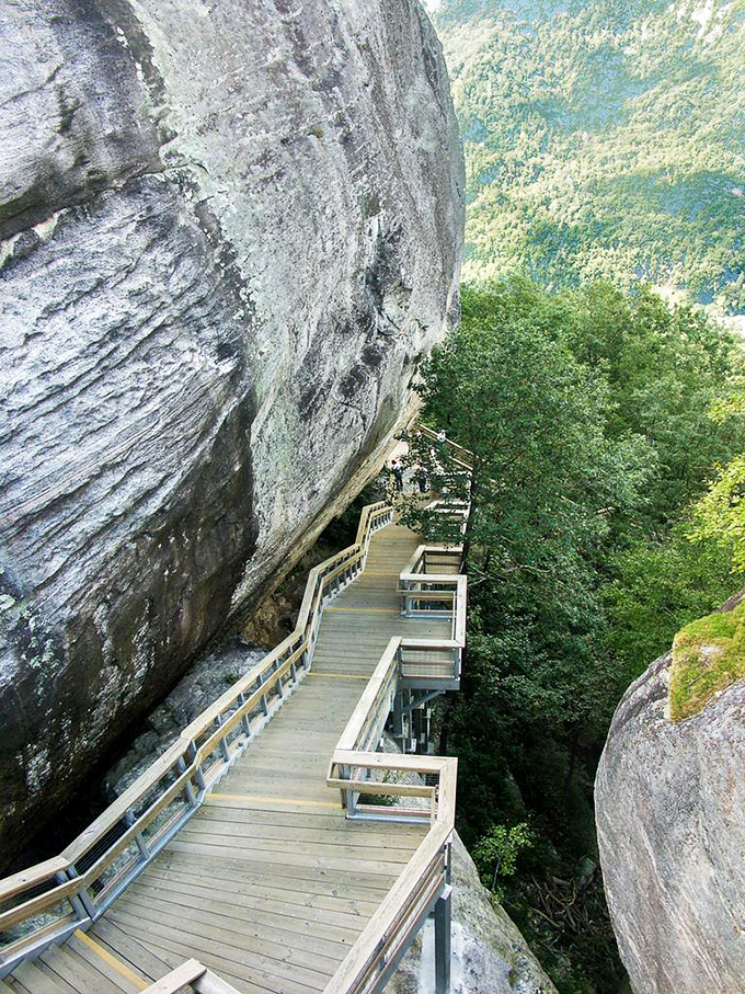 This wooden walkway hugs the mountainside like it's afraid of heights too, offering thrilling views that make your knees wobble and soul soar.