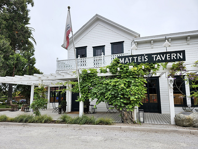 Mattei's Tavern stands as a living postcard from California's stagecoach era, its white clapboard exterior and climbing vines whispering stories of travelers past.