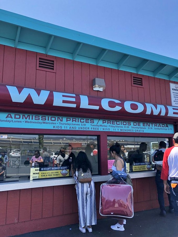 The cheerful red ticket booth welcomes visitors with bilingual signage, where a few dollars buys entry to a world of endless possibilities.