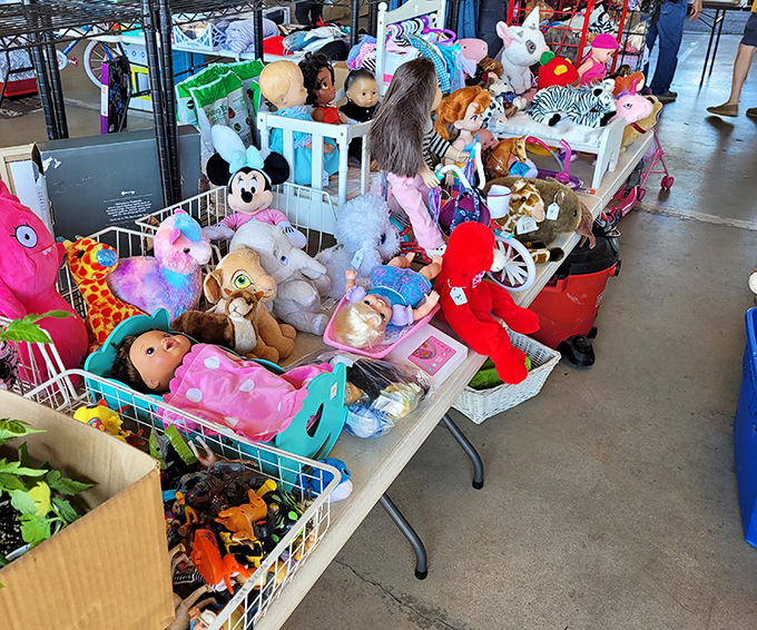 A plush menagerie awaits adoption at this colorful toy booth. From Mickey to teddy bears, each stuffed friend silently pleads, "Take me home!"