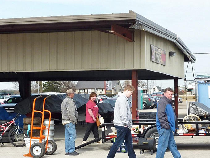 The outdoor vendor area transforms into a bustling marketplace where serious shoppers arrive with hand trucks, ready for heavy-duty treasure extraction.