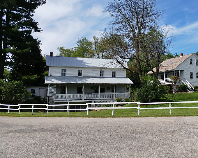 Simplicity speaks volumes. This classic white Amish farmhouse with its latticed porch tells a story of craftsmanship that predates power tools and prefab materials.
