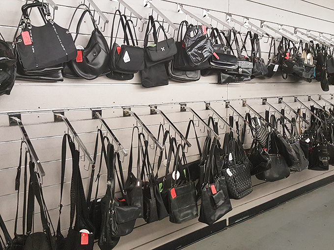 The wall of black handbags resembles a fashionista's dream closet, where yesterday's splurges become today's steals.