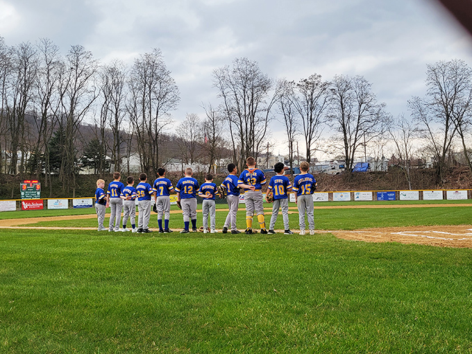 America's pastime alive and well! Young Blue Devils huddle on the diamond where community spirit is the real MVP of every game. 