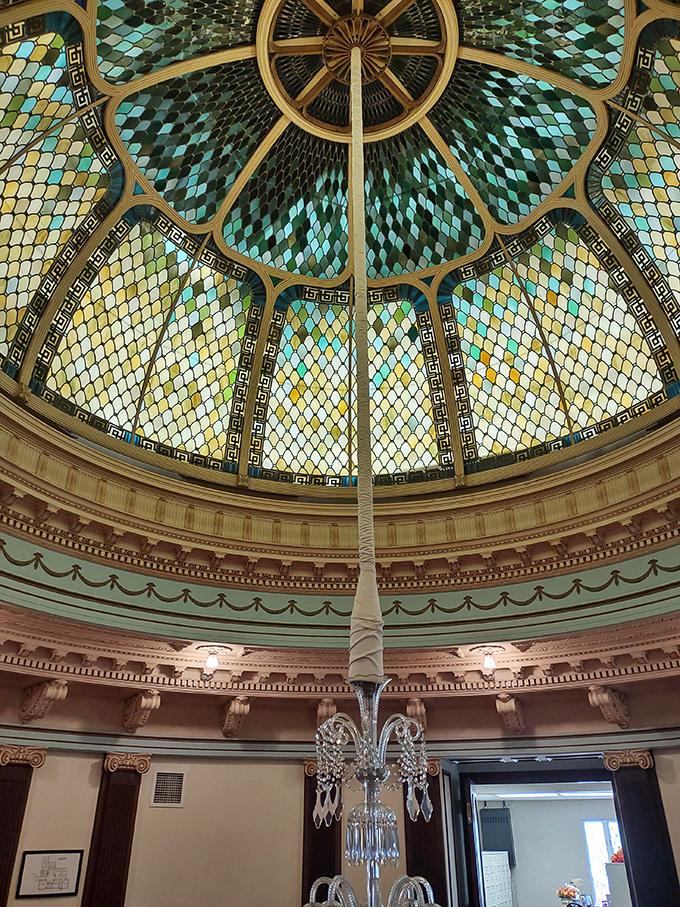 Look up! This breathtaking stained glass dome transforms ordinary sunlight into a kaleidoscope of blues and greens that would make Tiffany himself jealous.