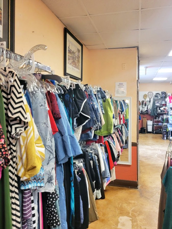 Rainbow-ordered garments line the walls like a fashionista's dream library, each hanger a chapter in someone else's story waiting for you to continue.