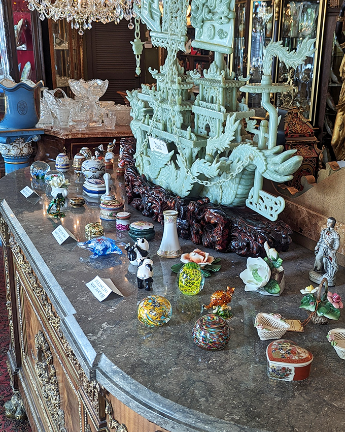 A treasure hunter's dream tableau – jade carvings and delicate figurines await their next caretaker while crystal catches light from every angle.