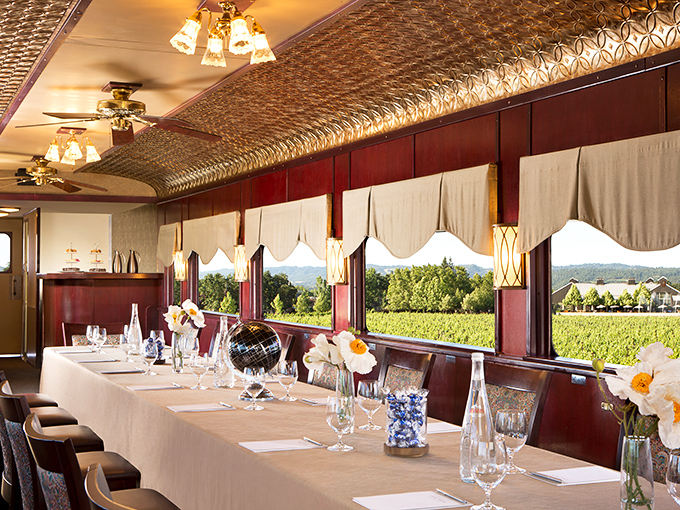 Elegance on rails: The dining car's embossed ceiling and pristine table settings prove that sometimes the journey truly outshines the destination.