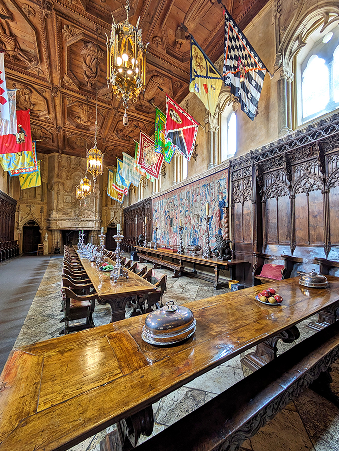 The Refectory's dining table stretches longer than most people's mortgage payments, while colorful heraldic banners hang overhead like medieval Instagram filters.