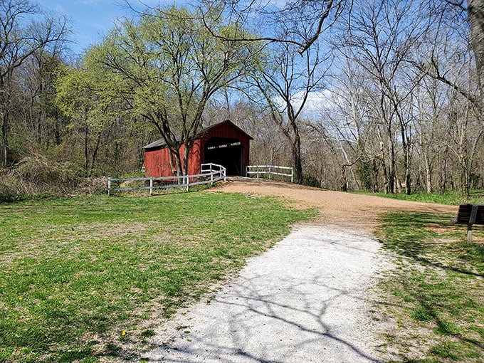 From a distance, the crimson bridge creates a perfect postcard moment, nestled among spring greenery like a historical jewel in Jefferson County's crown.