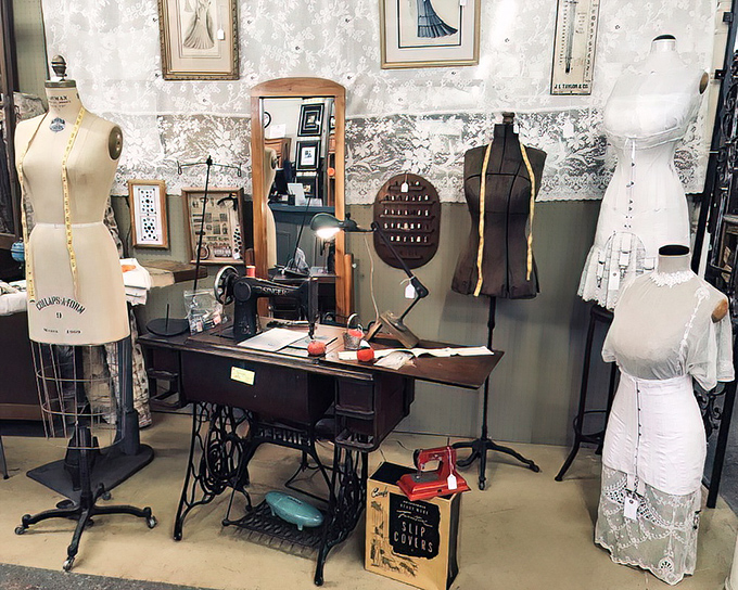 A seamstress's paradise frozen in time. These vintage dress forms and that classic Singer sewing machine whisper stories of handmade wardrobes from generations past.