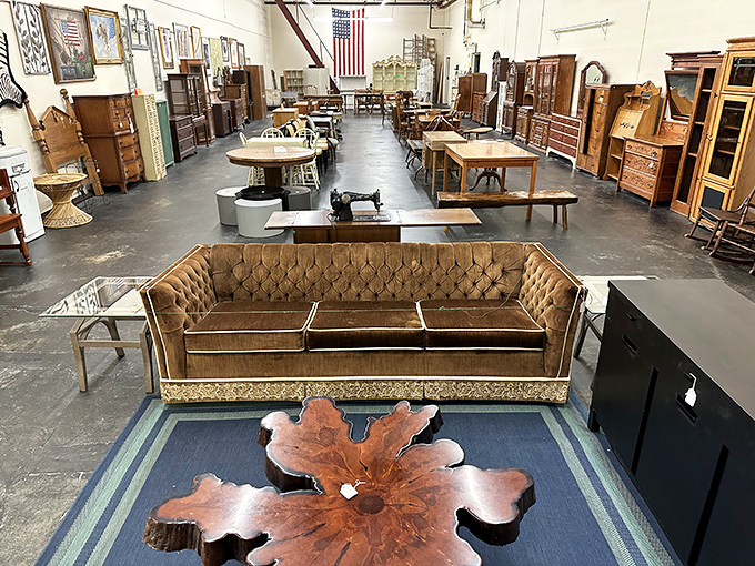 The velvet tufted sofa commands the room like a 1970s game show host &ndash; confident, slightly gaudy, and impossible to ignore.