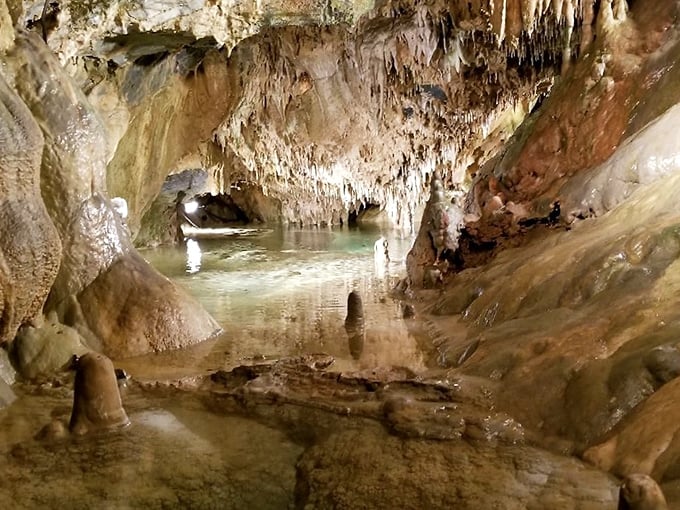 Underground waterways reflect centuries of geological artistry, creating mirror images that challenge your sense of up and down.