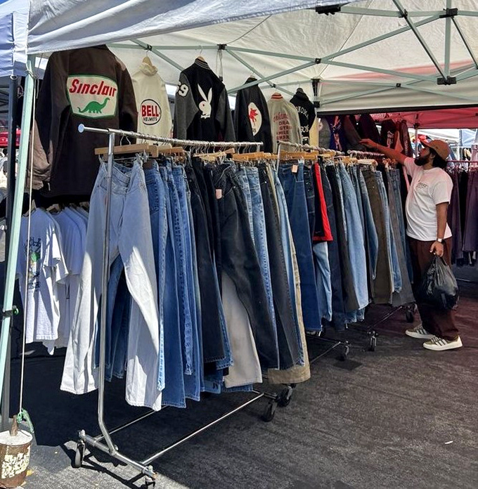 Denim dreams hanging in perfect rows. Vintage Levi's and graphic tees await their second life with new owners who appreciate worn-in character.