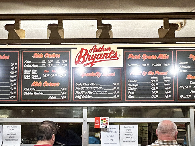The menu board tells a story of smoked meat mastery. Each item represents decades of perfection, not just food but edible history. 