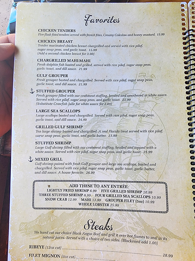 A menu that reads like a love letter to the Gulf. That anchor symbol next to the Stuffed Grouper? It's saying "drop everything and order me."