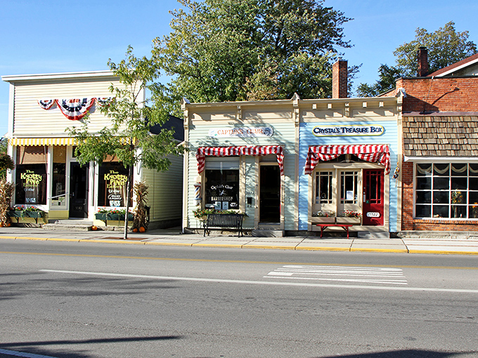 These charming storefronts aren't playing dress-up – they're the real deal, complete with candy-striped awnings that practically demand a stroll.