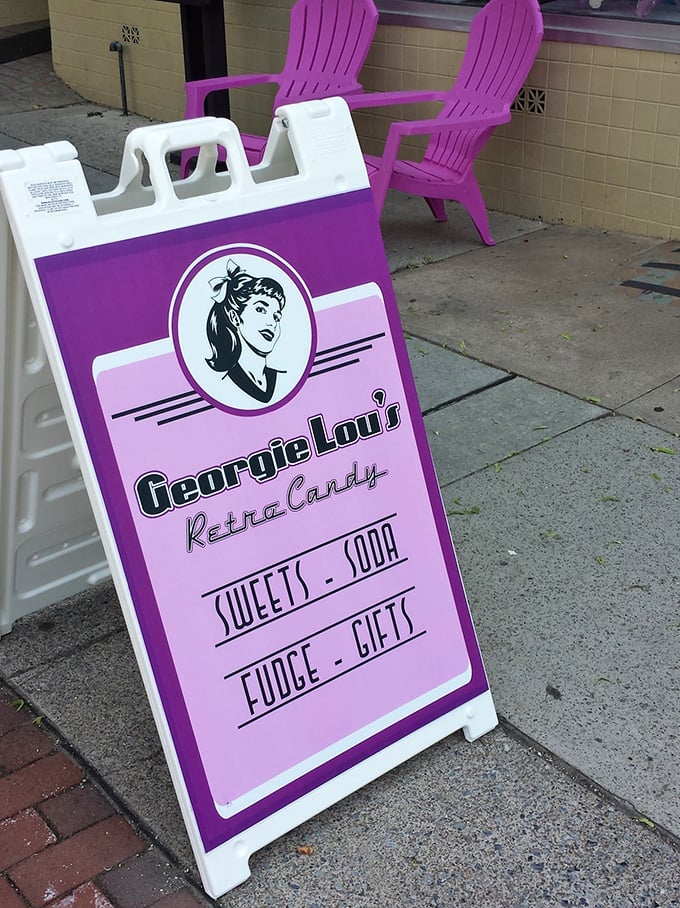 Those purple chairs aren't just seating&mdash;they're your invitation to slow down and savor. The sign promises four food groups: sweets, soda, fudge, and gifts.