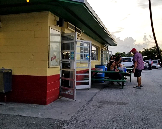 The yellow and red snack bar building stands ready for intermission rushes, where movie memories are made between buttery fingers.