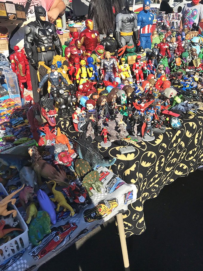 Superhero headquarters or nostalgic time machine? Batman stands guard over an army of action figures that would make any collector's heart skip a beat.