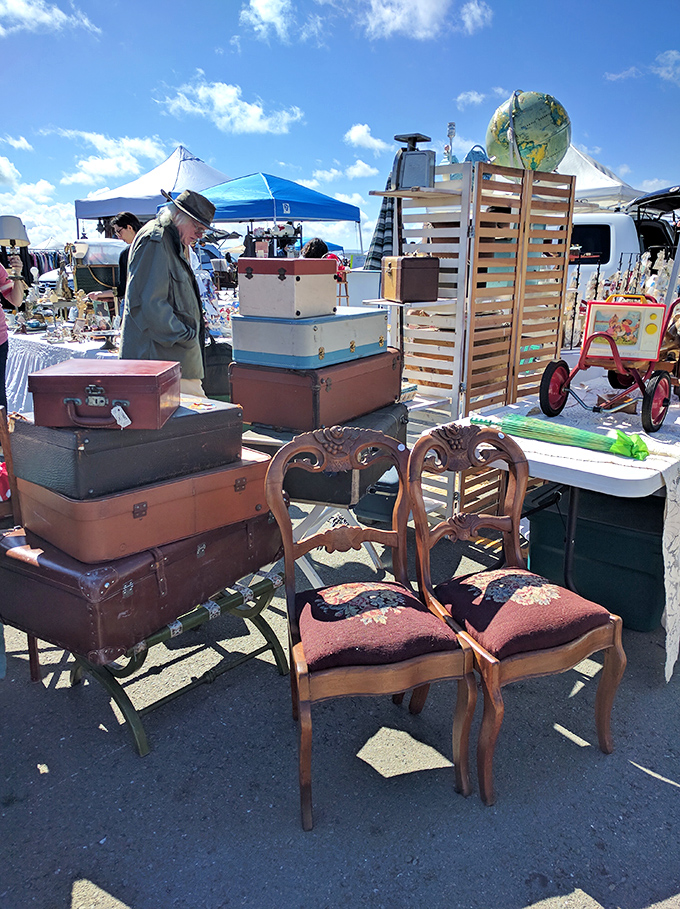 Vintage suitcases stacked like time capsules next to elegant chairs that have witnessed decades of dinner conversations. If furniture could talk!
