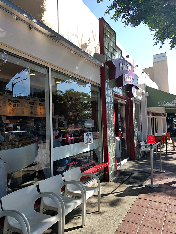 Diddy Riese's cookie kingdom beckons with its simple storefront. College students have been making memories here for decades.