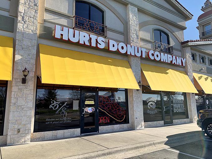 Yellow awnings brighter than morning sunshine! Hurts Donut Company's storefront promises a sugar rush worth every calorie.