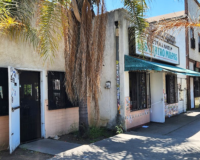Las Cuatro Milpas' weathered exterior tells the story of decades serving comfort food that transcends language barriers.