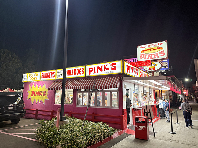 Pink's neon glow transforms an ordinary corner into hot dog heaven. The line? Consider it a preview of coming attractions!