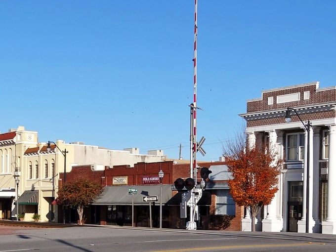 "The railroad crossing stands sentinel over Dillon's quiet streets. That autumn tree is nature's way of adding a pop of color to the scenery."