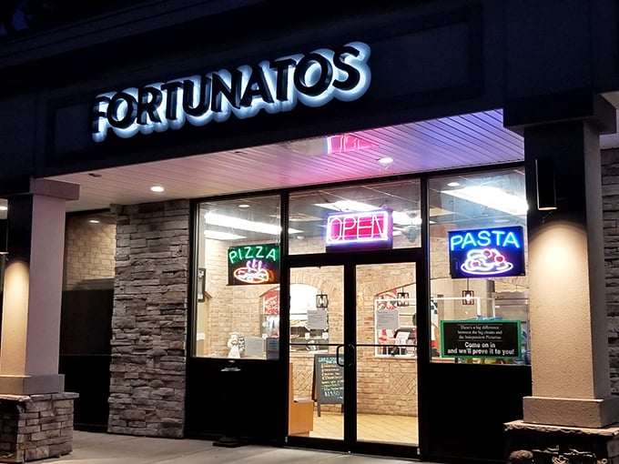 Night transforms Fortunato Brothers into a glowing beacon of pizza possibility. Those neon signs in the window whisper delicious promises to passersby.
