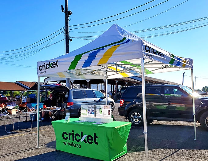 A bright green pop of modern tech in a sea of flea market finds, ready to keep bargain hunters connected while they browse.