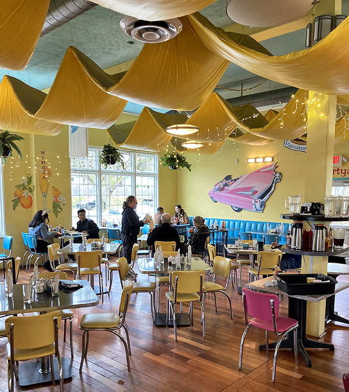 The fabric-draped ceiling and vintage car decor create the feeling you're having breakfast inside the world's happiest, most delicious circus tent.