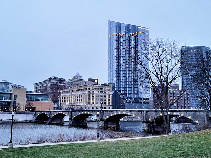 The Grand River flows beneath historic bridges in downtown Grand Rapids, where old industrial charm meets modern city life.