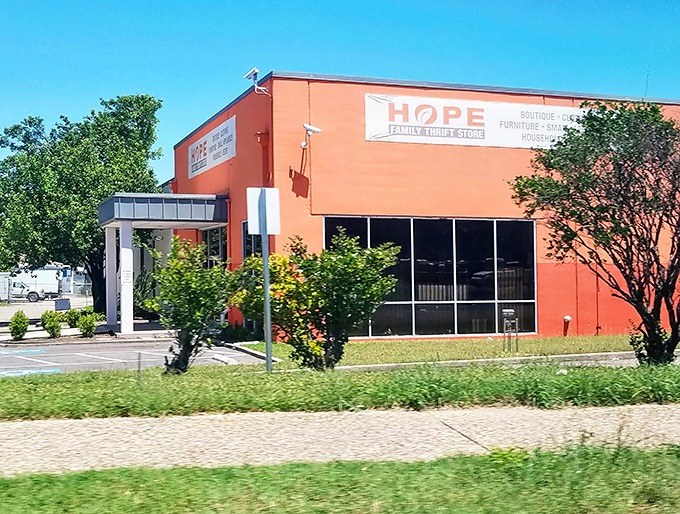 Sunshine bathes the peachy facade of HOPE Family Thrift, where every purchase plants seeds of help in the community.