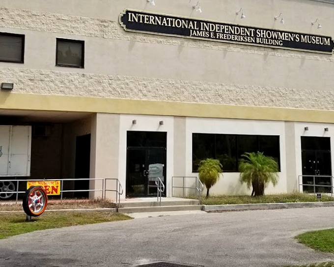 The sign promises showmen's treasures, but the real magic happens when you step through those unassuming doors.