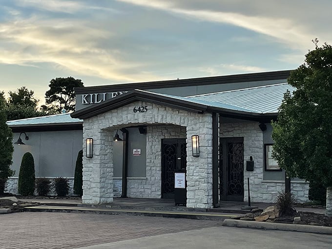 Evening at Killen's Steakhouse&mdash;where the stone exterior gives way to a warm glow that whispers, "Come hungry, leave happy."