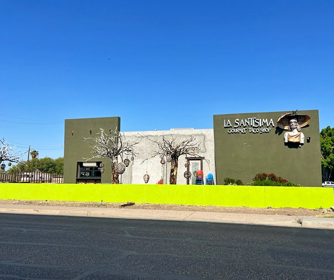 That eye-catching yellow fence at La Santisima is like a neon sign saying "extraordinary tacos here!" Desert landscaping meets culinary creativity.