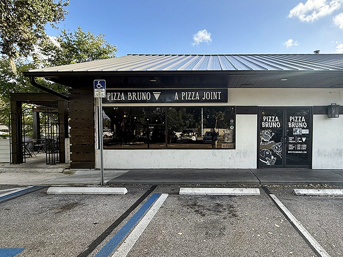 Pizza Bruno's minimalist storefront hides maximum flavor potential. That "A PIZZA JOINT" sign understates what pizza aficionados know is exceptional.