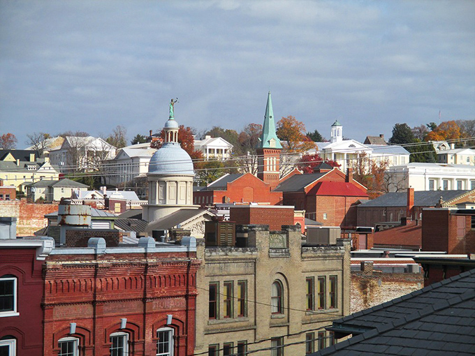 Downtown Staunton glows in golden hour light, its historic buildings standing proud against a backdrop of blue sky.