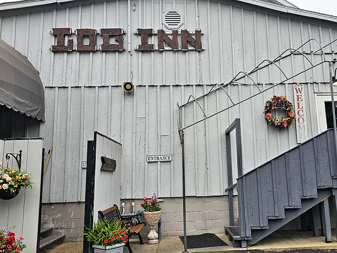 Around back, the rustic charm of The Log Inn continues. That "Welcome" wreath isn't just decoration&mdash;it's a promise of the hospitality waiting inside.