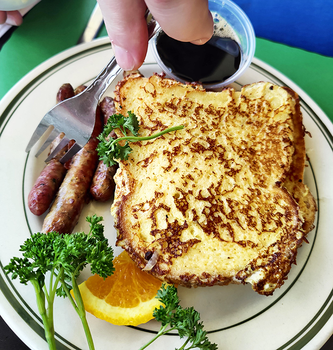 Golden-brown French toast that's been kissed by the griddle, served alongside sausage links that snap with each bite&mdash;breakfast perfection defined.
