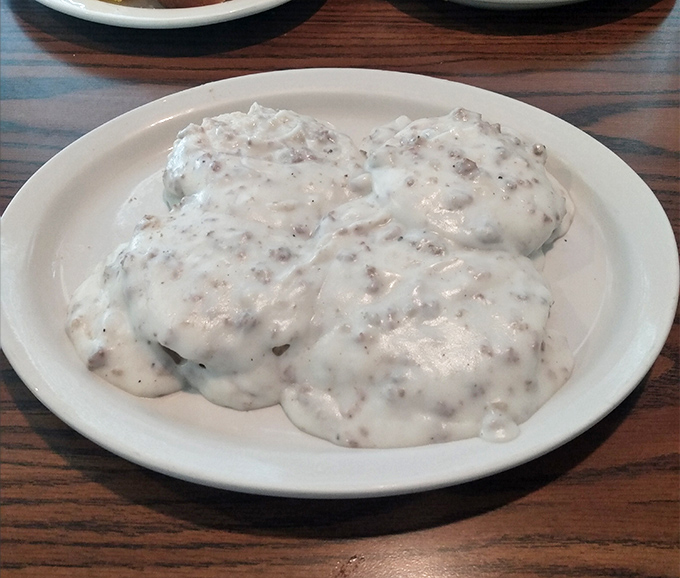 Biscuits drowning in gravy like fluffy clouds in a delicious thunderstorm &ndash; this is how mornings were meant to begin.