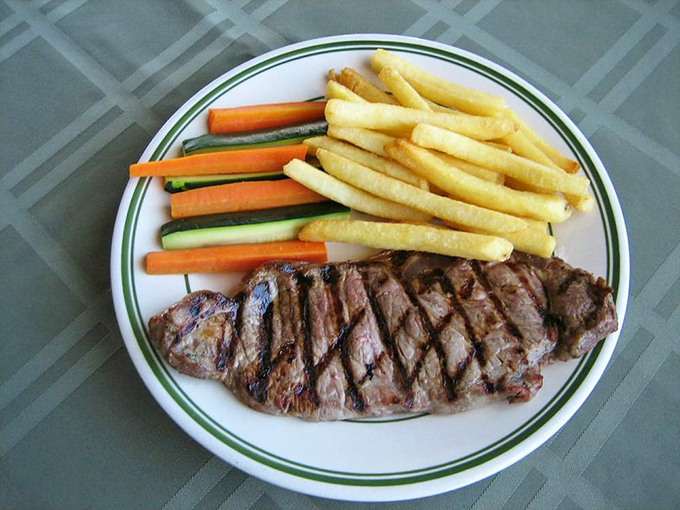 Behold the star of our show&mdash;the NY steak with perfect grill marks that whisper "I was cooked by someone who cares." Those fries and veggies aren't just sides, they're supporting actors deserving their own award.